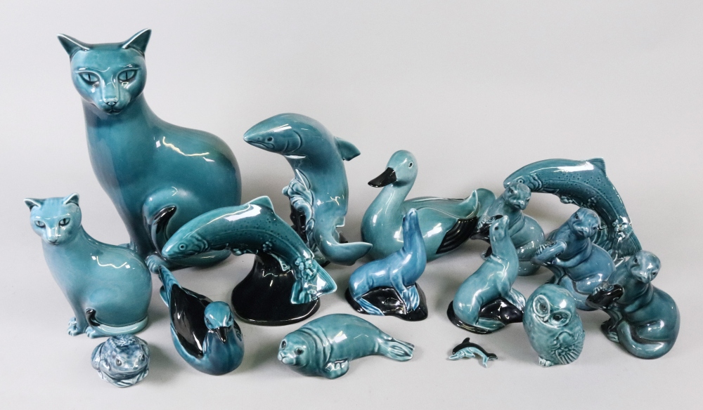 A collection of sixteen dolphin blue Poole Pottery figures of animals ...