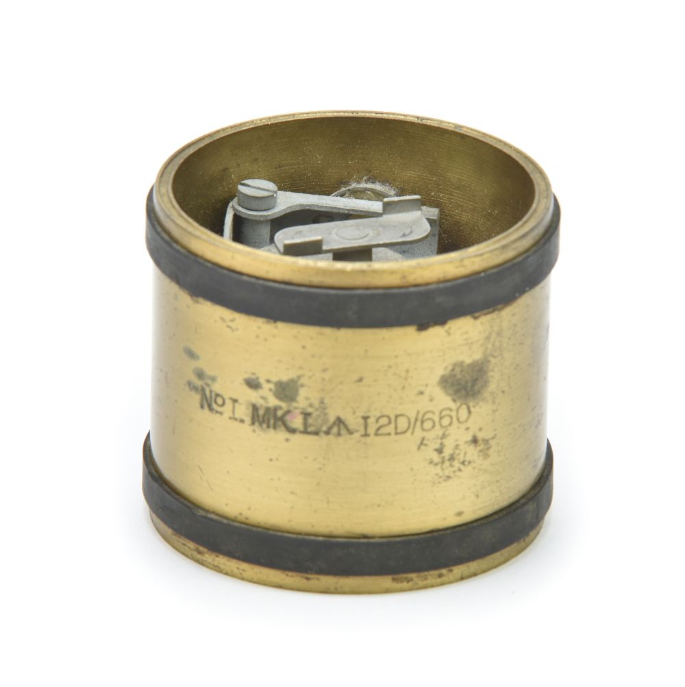 * Bomb Fuse Timer. A WWII Artillery bomb fuse timer, the circular brass ...