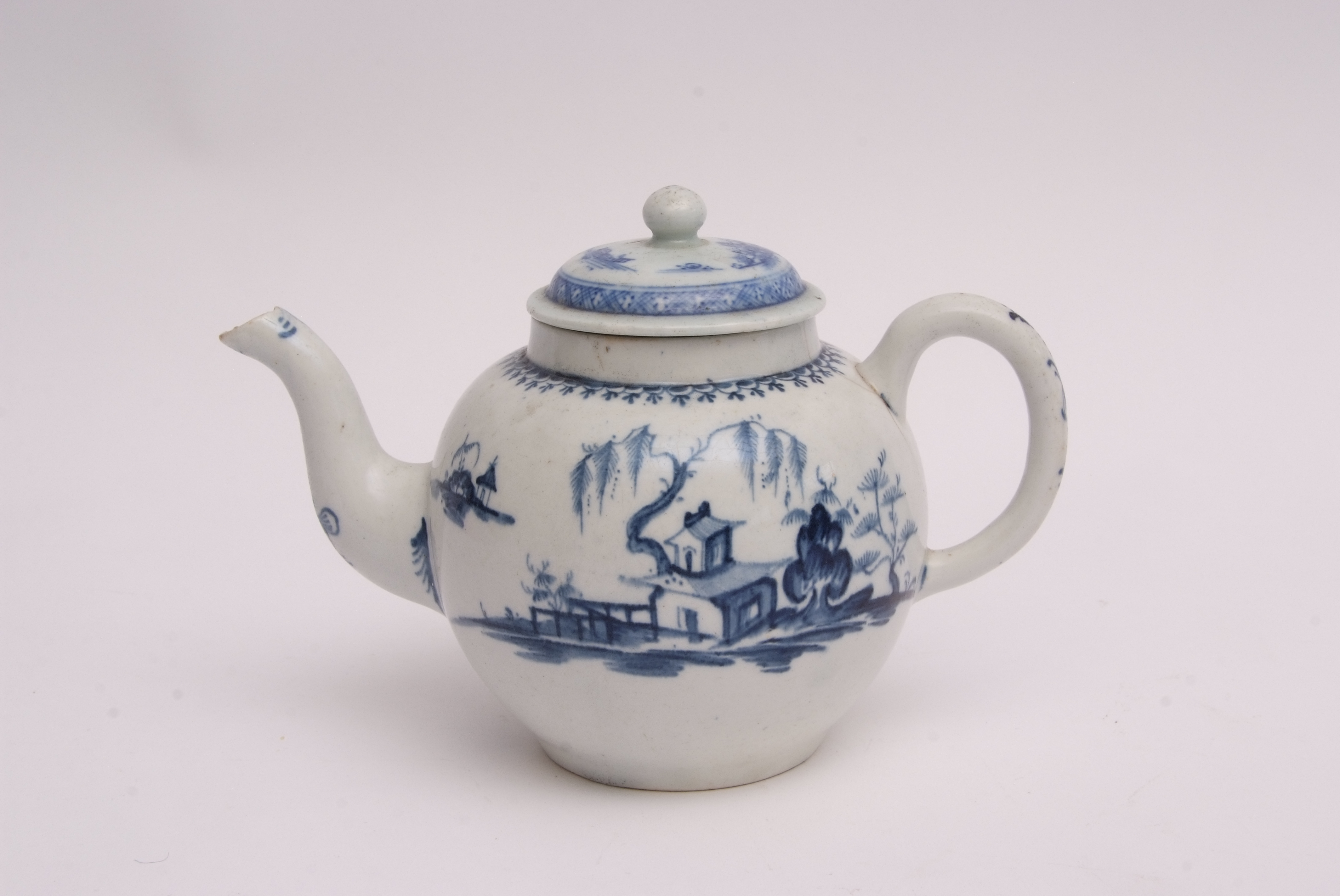 Lowestoft blue and white teapot with berry border above river island ...
