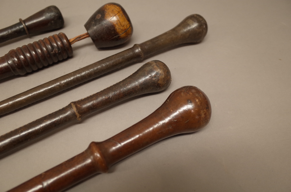 Four leather bound weighted coshes/whips and one further wood and ...