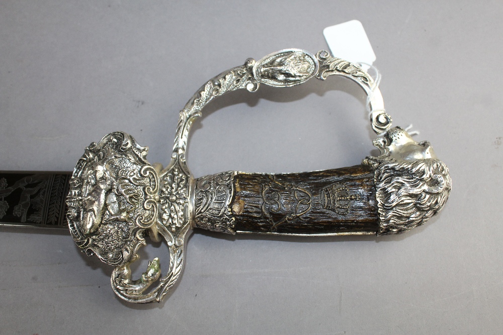A Reproduction hunting sword having antler type handles and silver ...