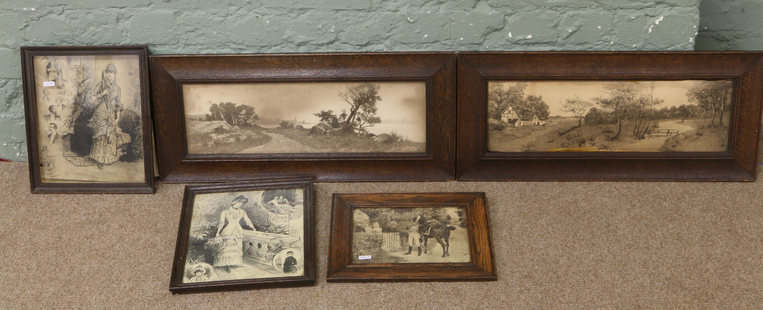 A collection of oak framed prints.