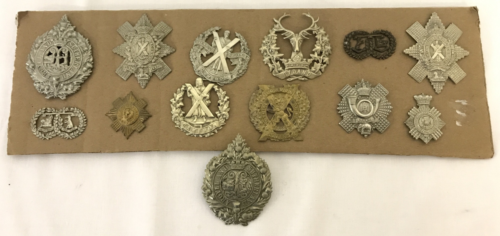 A collection of 13 original WWII era Scottish Regiments 2 lug cap ...