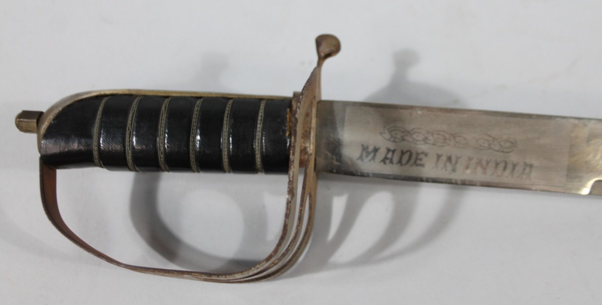 A 20thC Indian sabre dress sword, with metal and pressed black scabbard ...