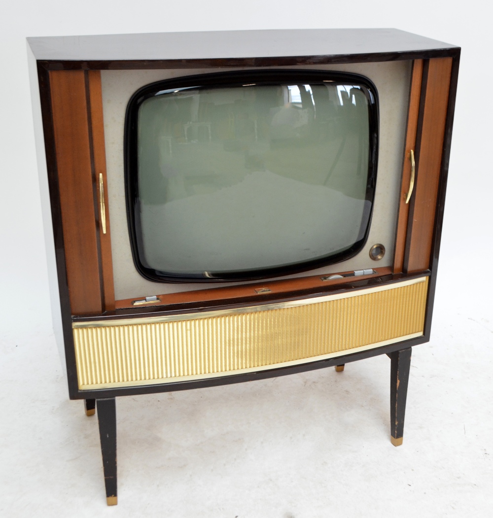 A vintage HMV television in cabinet with sliding tambour doors and ...