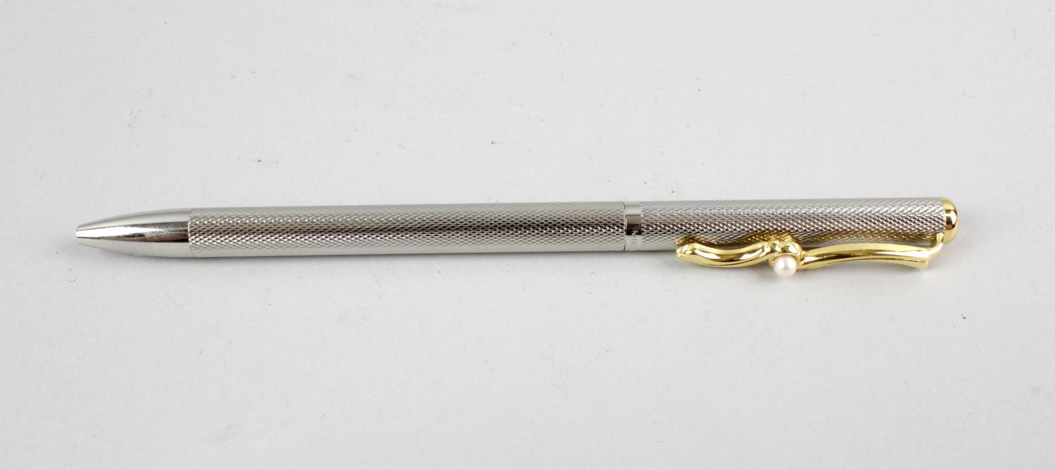 A Mikimoto ballpoint pen, the gilt clip inset with a pearl, the silver ...