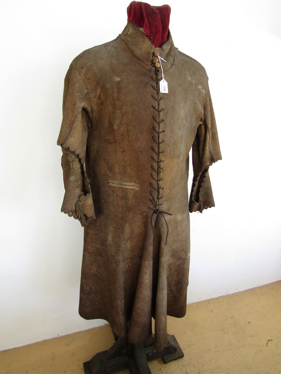A reproduction 17th Century buff coat and stand