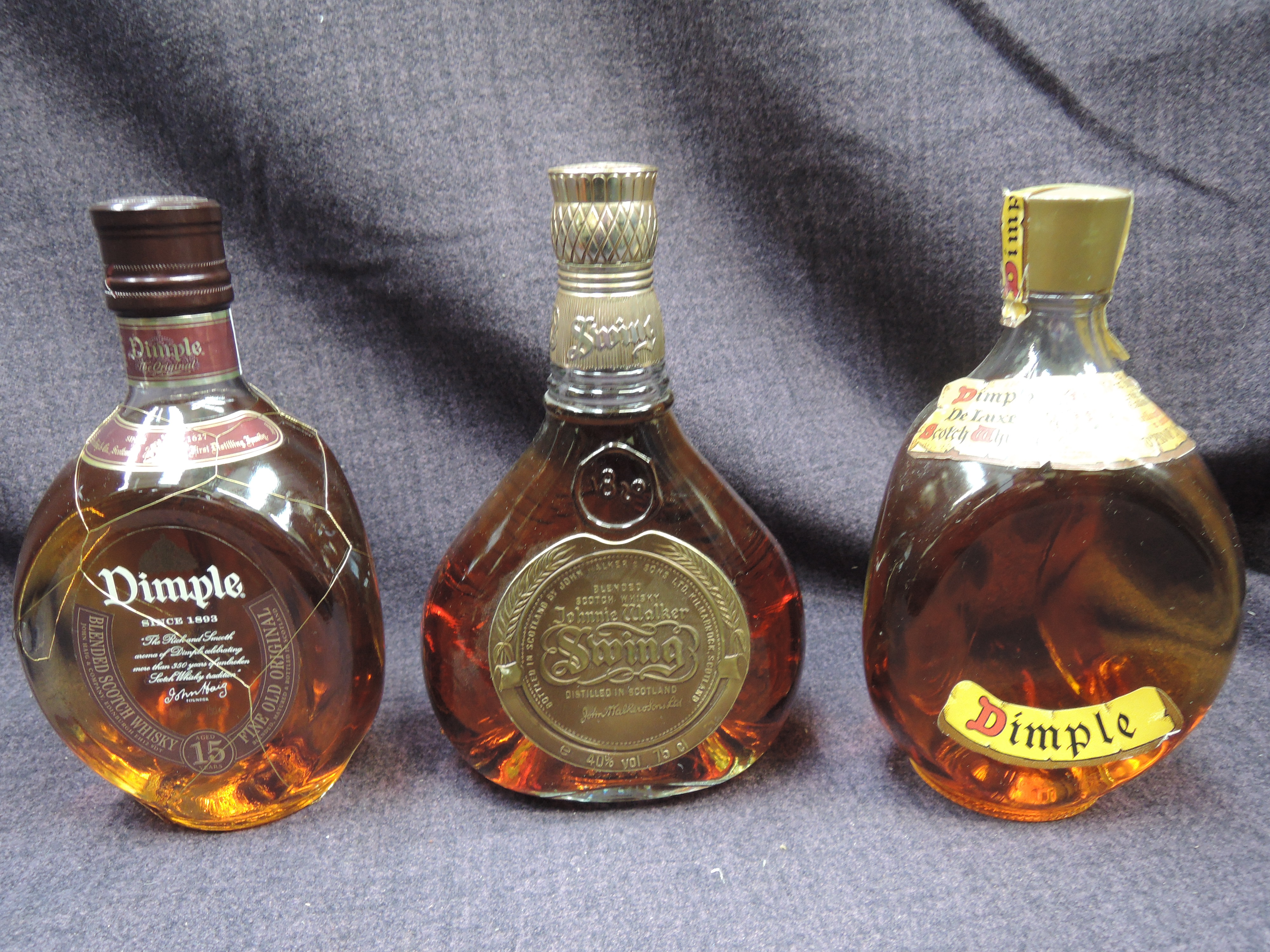 Three bottles of whisky. Dimple 15 year old, 40%, 75cl, Dimple Deluxe ...