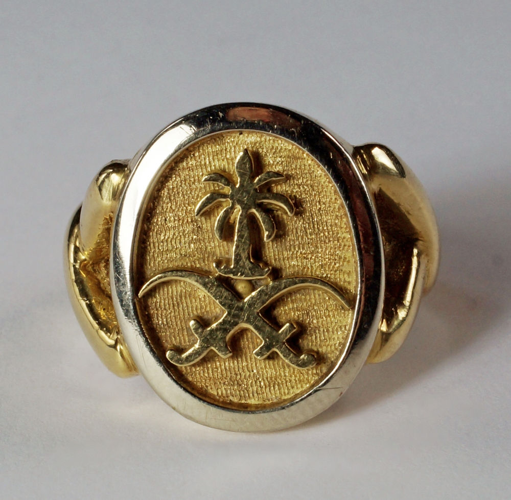 An 18ct gold signet ring, of oval form, cast with Saudi Arabia emblem ...