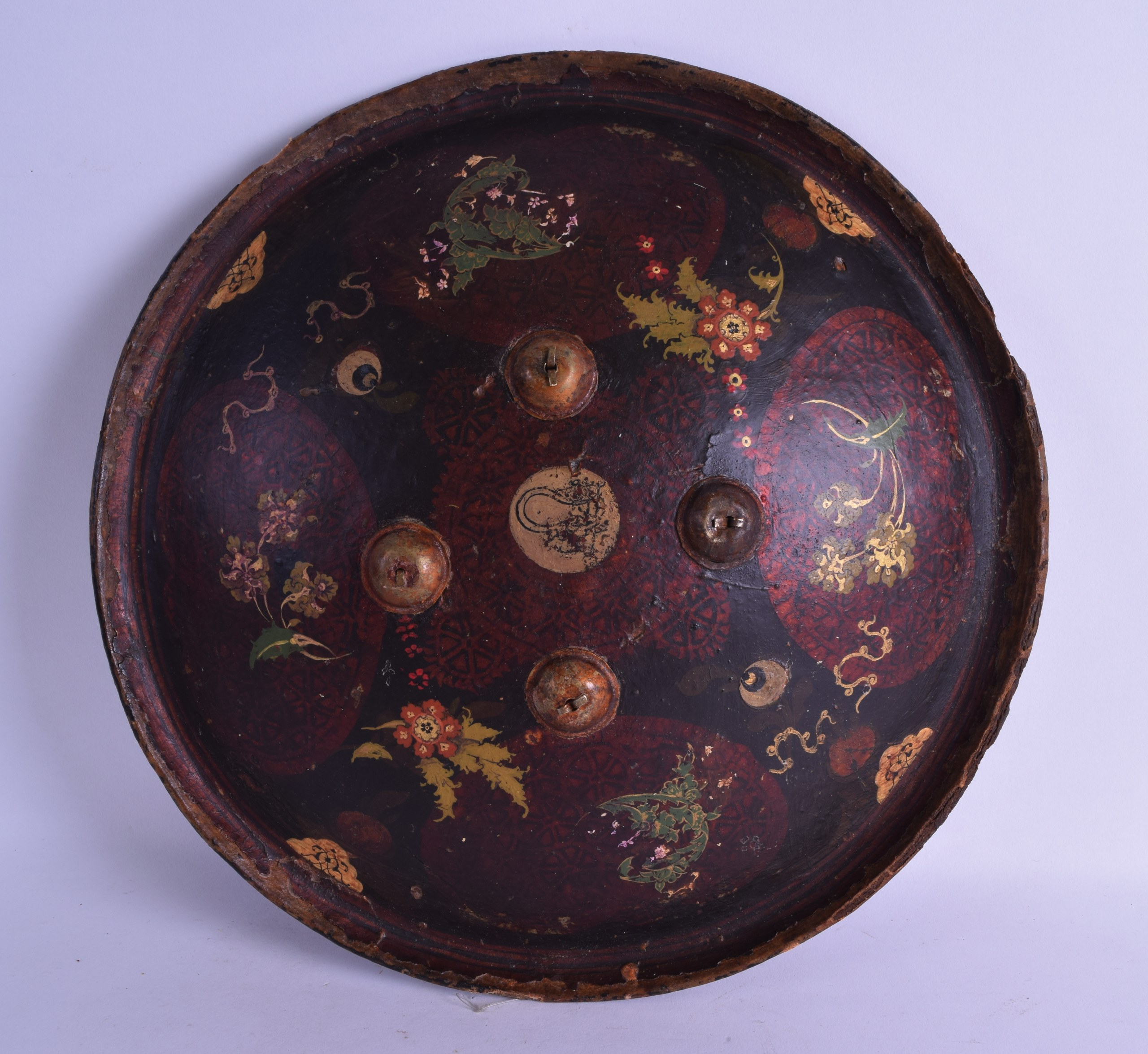 AN UNUSUAL TURKISH OTTOMAN PAINTED AND LACQUERED SHIELD decorated with ...