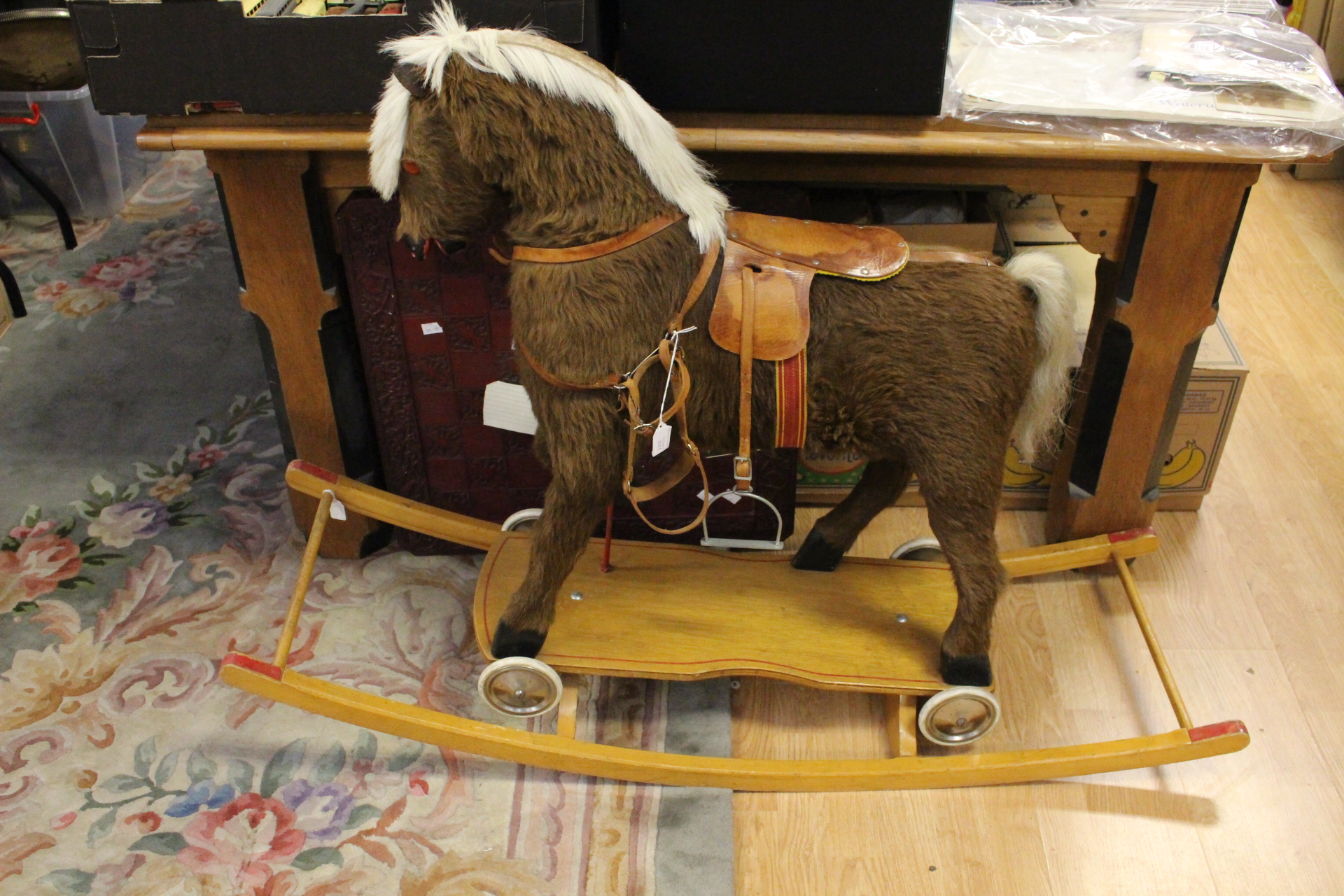 A circa 1950s horse hair rocking horse with wheels