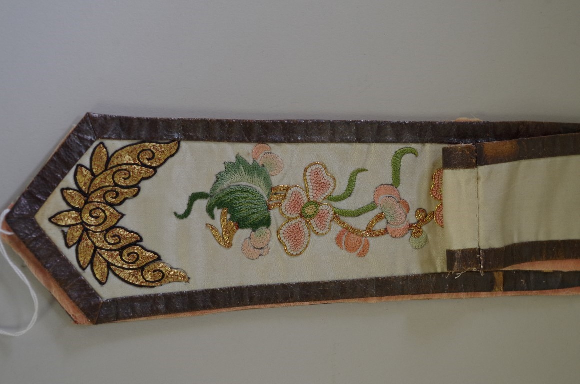 A Chinese embroidered silk sash, probably 19th century; together with ...