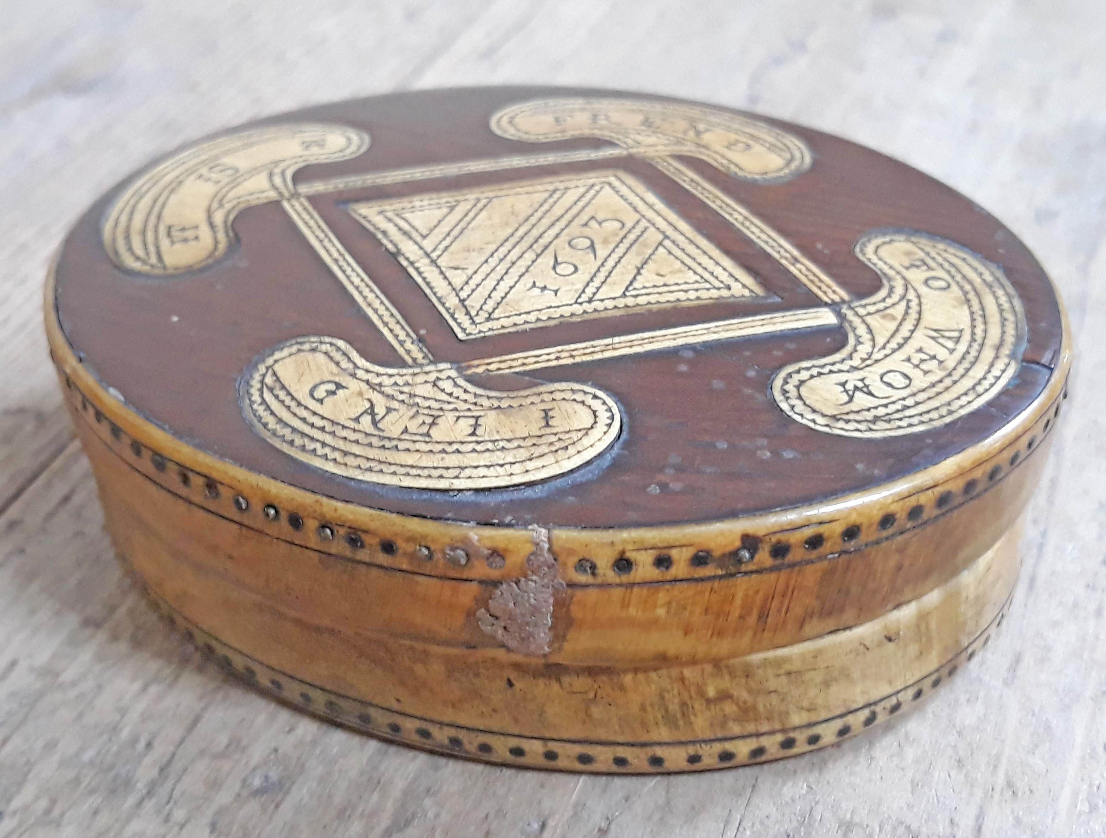 A 17th Century horn and wood snuff box of oval form with verse to top ...