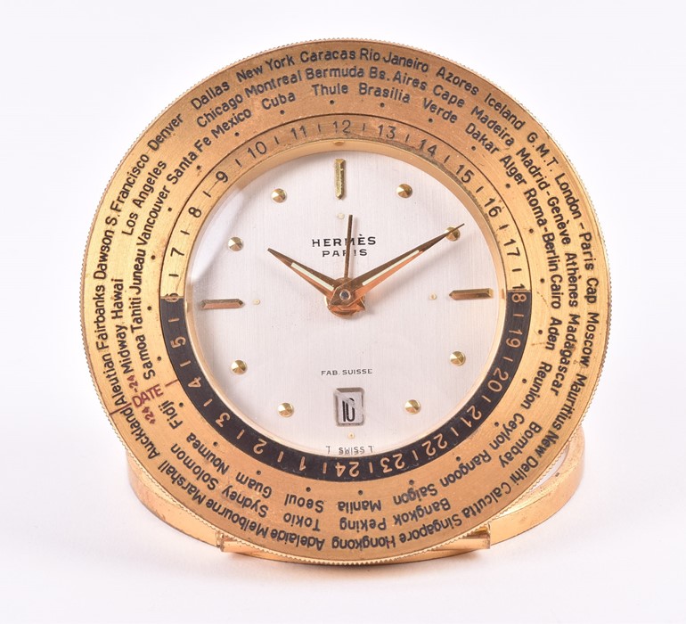 A Hermes world time travel desk clockthe face with gilt studs for ...