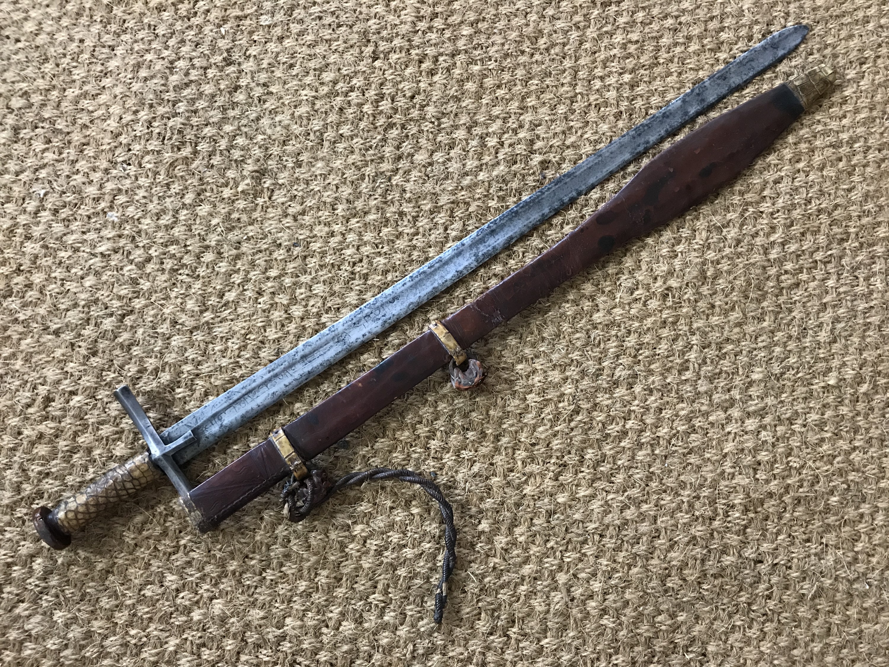 A Sudanese kaskara / sword, the blade bearing engraved Islamic script ...