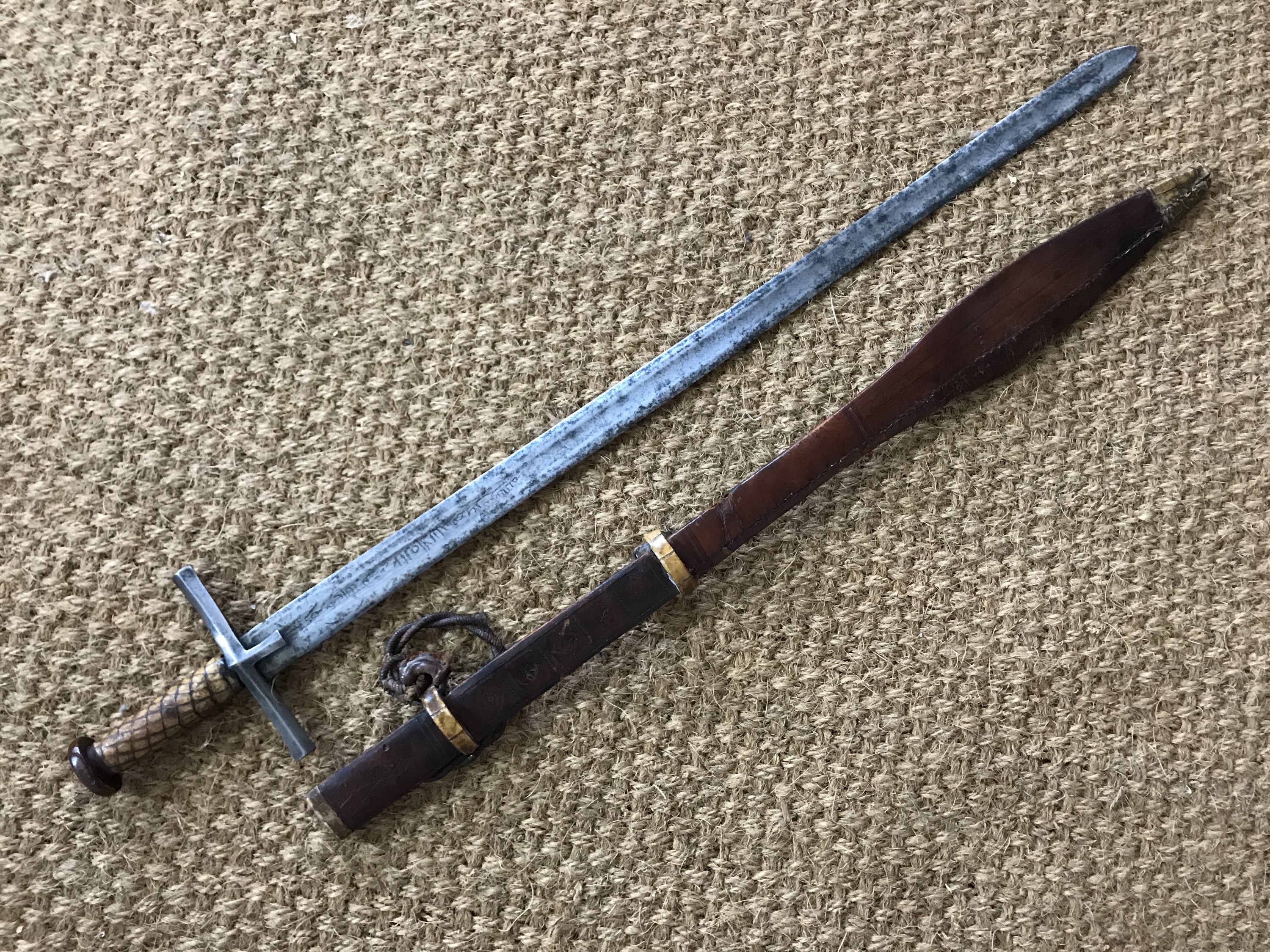 A Sudanese kaskara / sword, the blade bearing engraved Islamic script ...