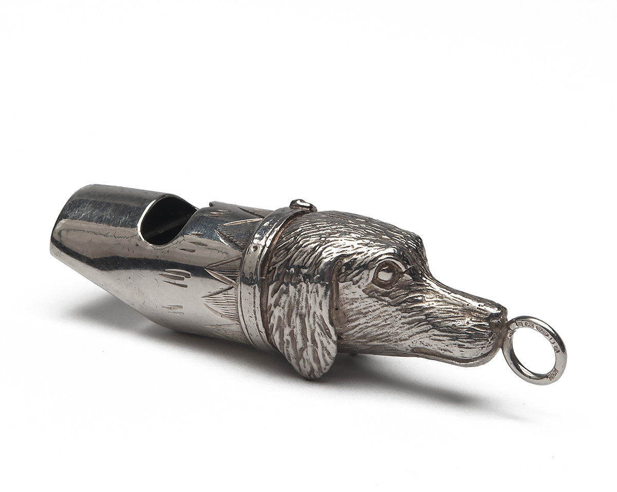 A STERLING SILVER DOG WHISTLE,in the form of a retriever head, the nose ...