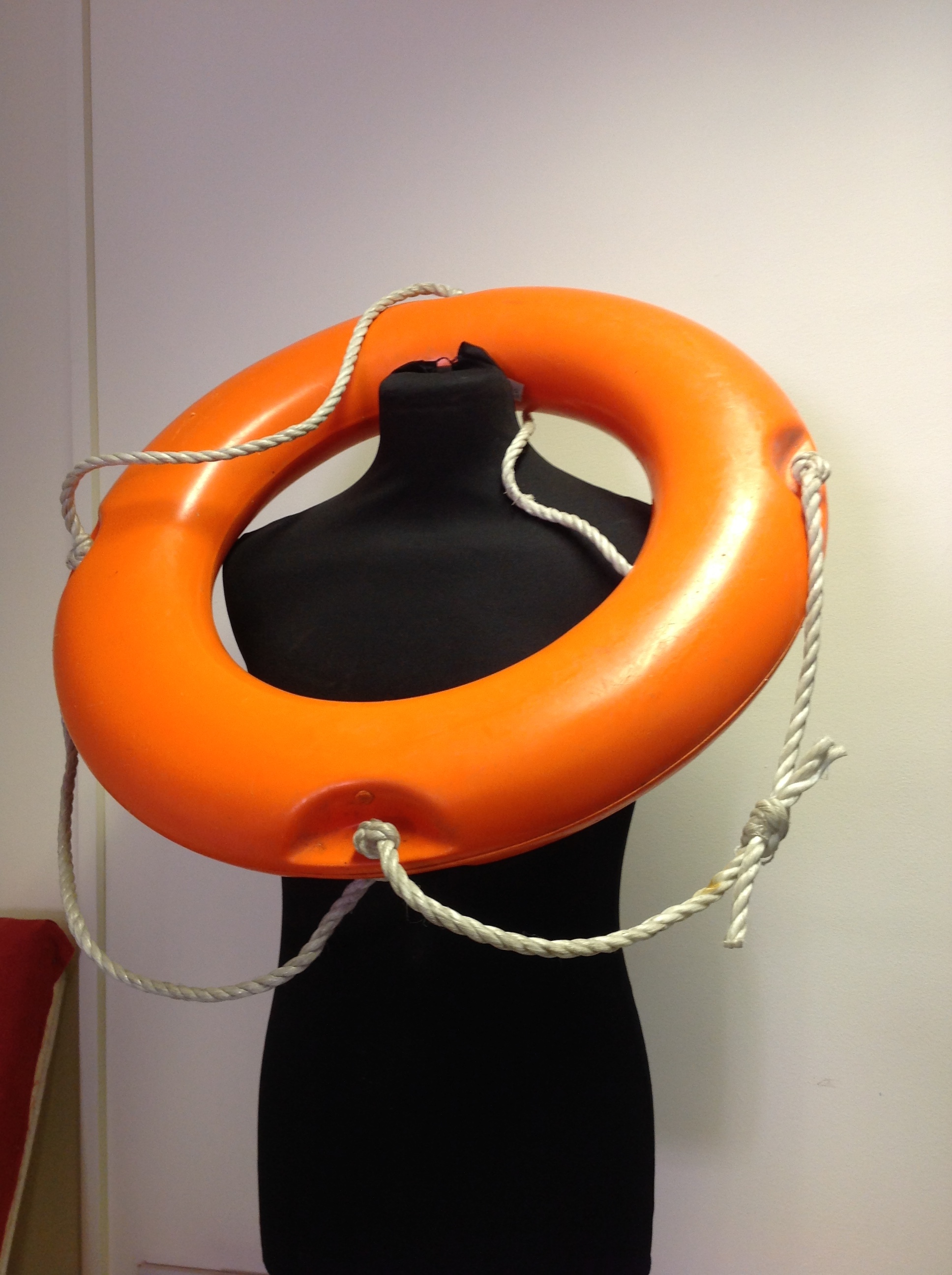 Orange lifeboat buoyancy aid ring plus a small unsigned painting of a ...