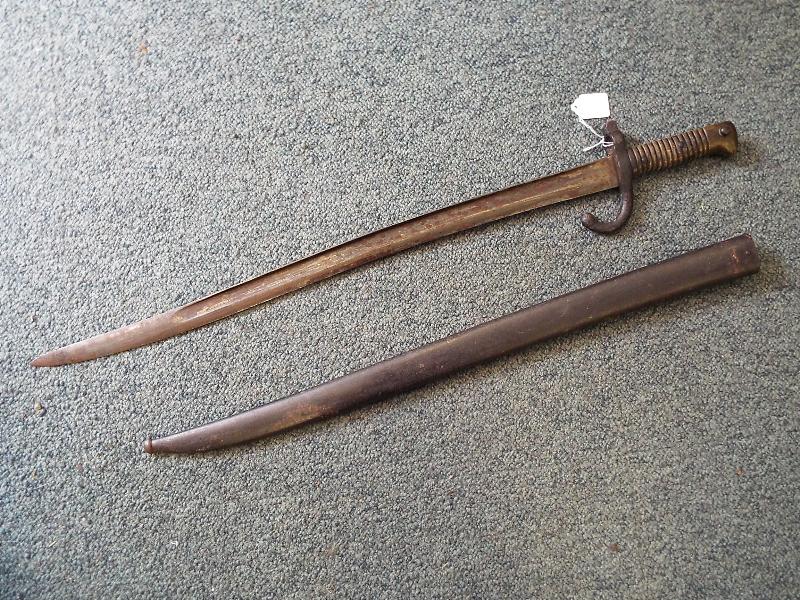 A 19th century French curved sword bayonet with brass handle and metal ...