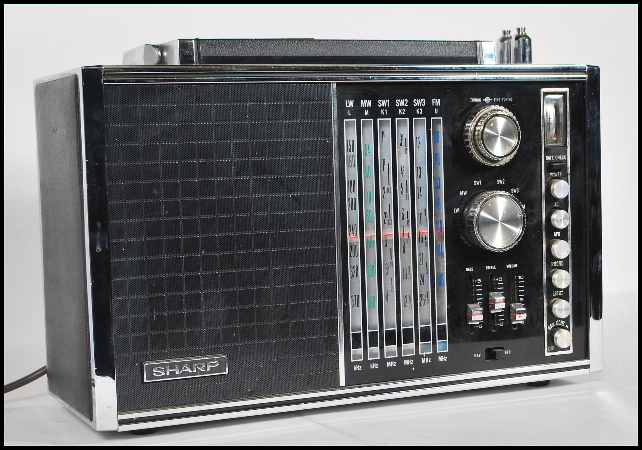 A vintage Sharp made FV-1800 6 Band portable radio. Black, with silver ...