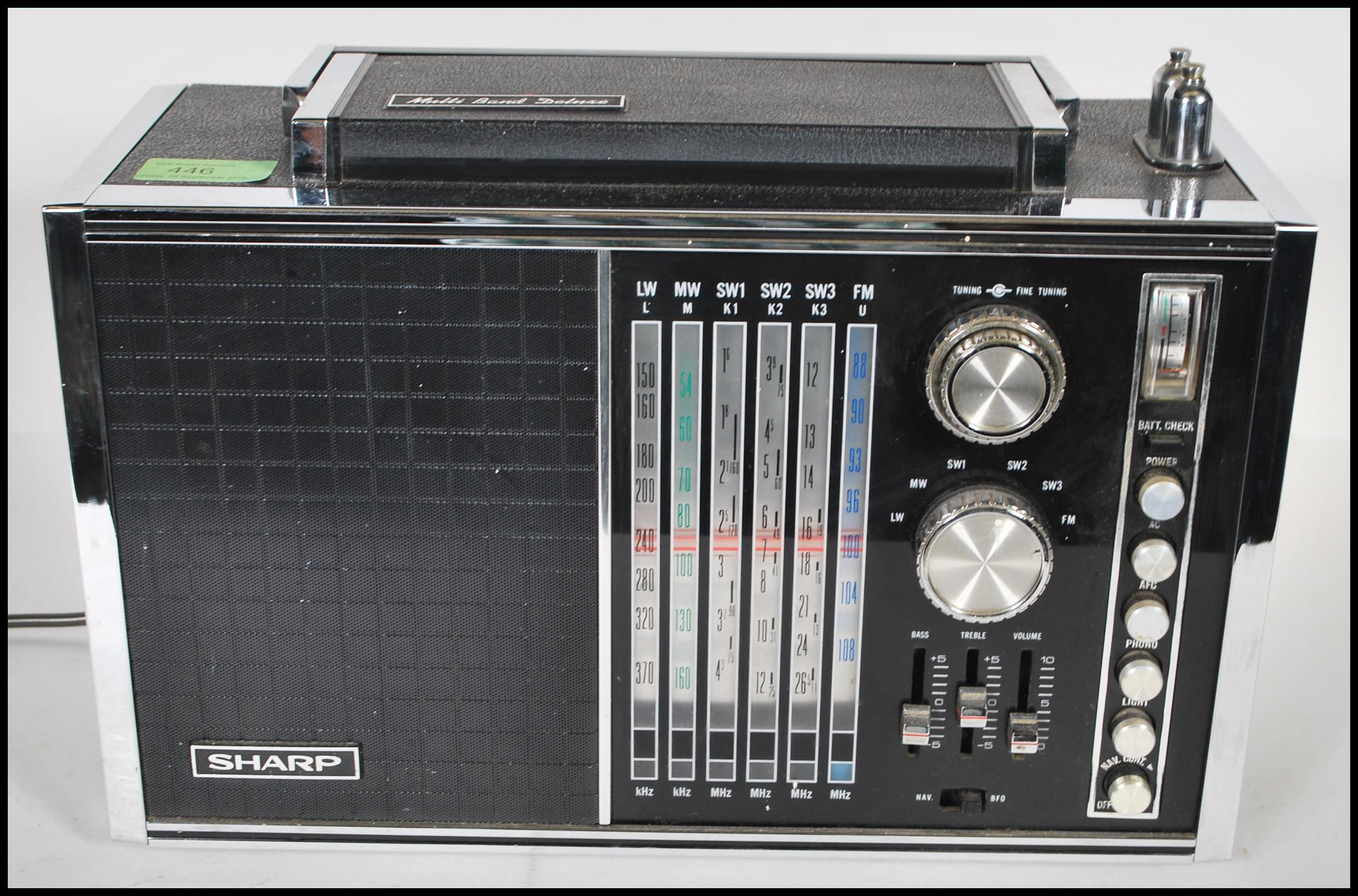 A vintage Sharp made FV-1800 6 Band portable radio. Black, with silver ...