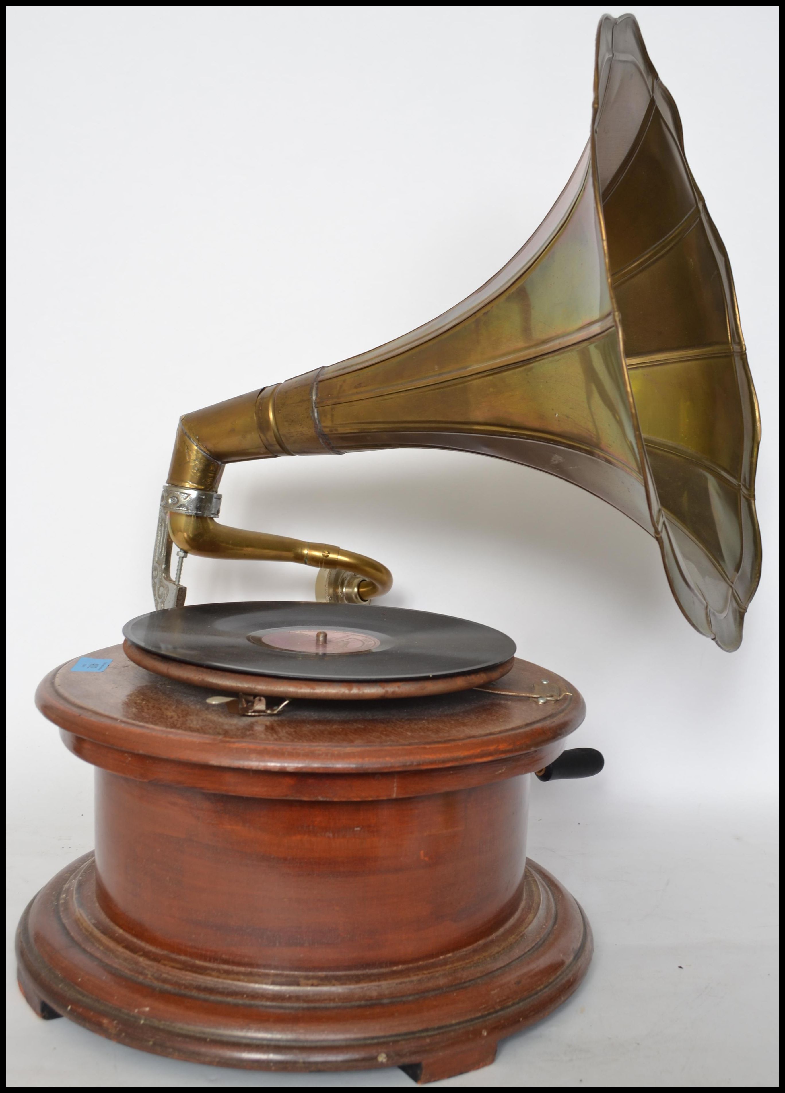 An vintage wooden gramophone with morning glory brass horn, the base of ...