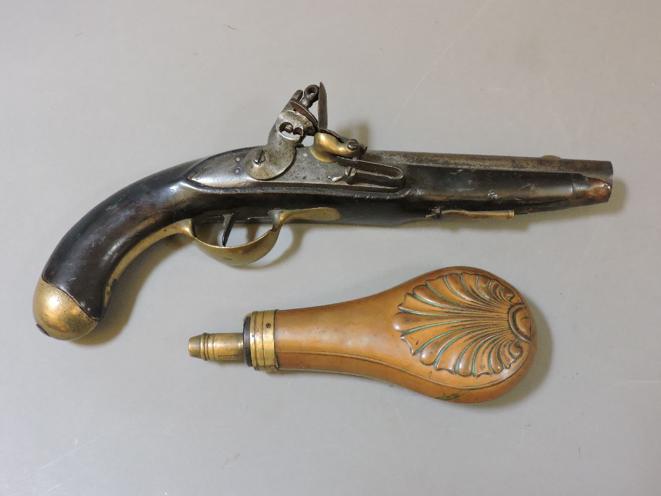 An early 19th century flintlock pistol, with brass mounts and trigger ...