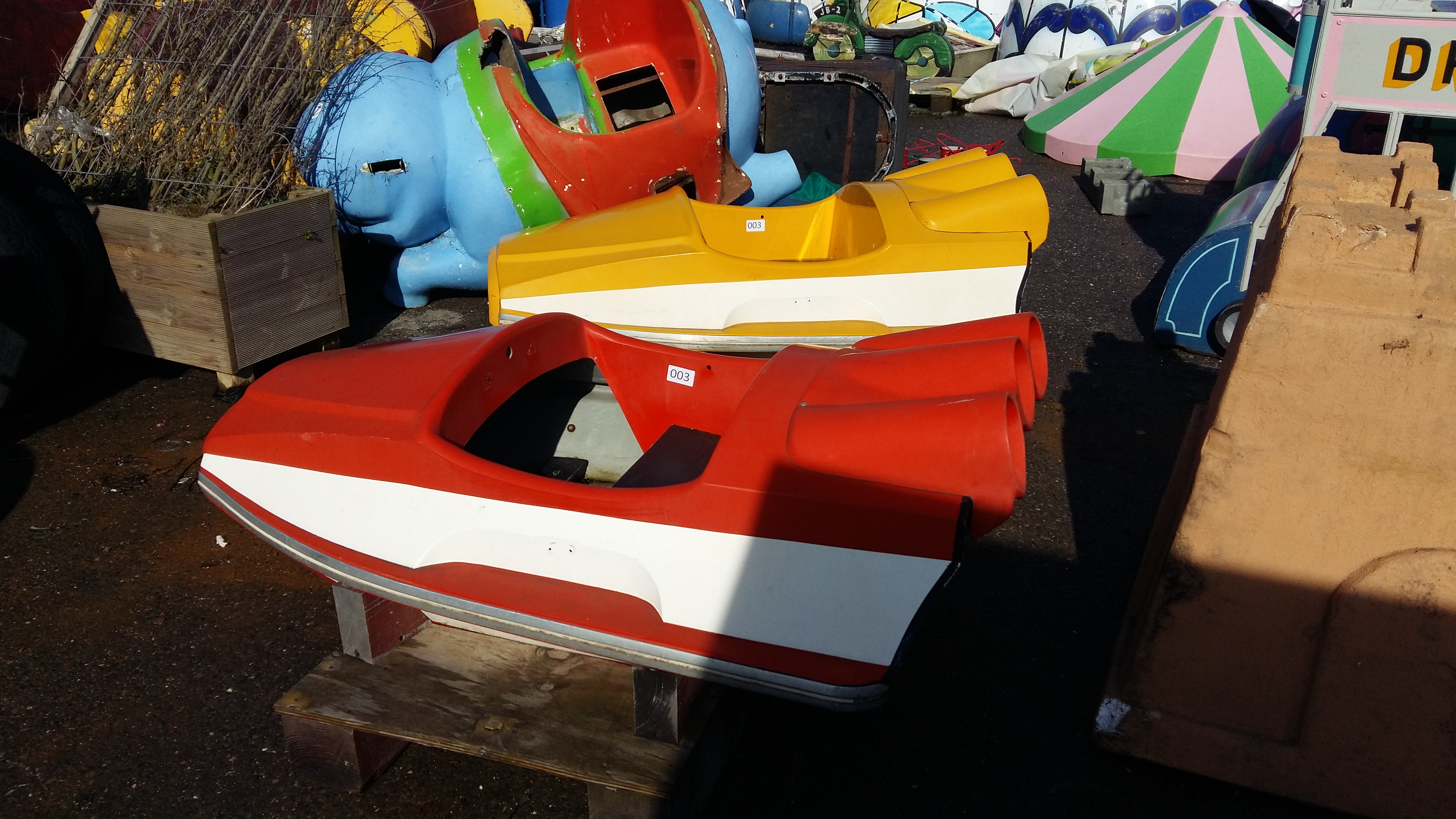 (2) Fibreglass 'Rocket' ride cartsSingle position carts(1) Red and ...