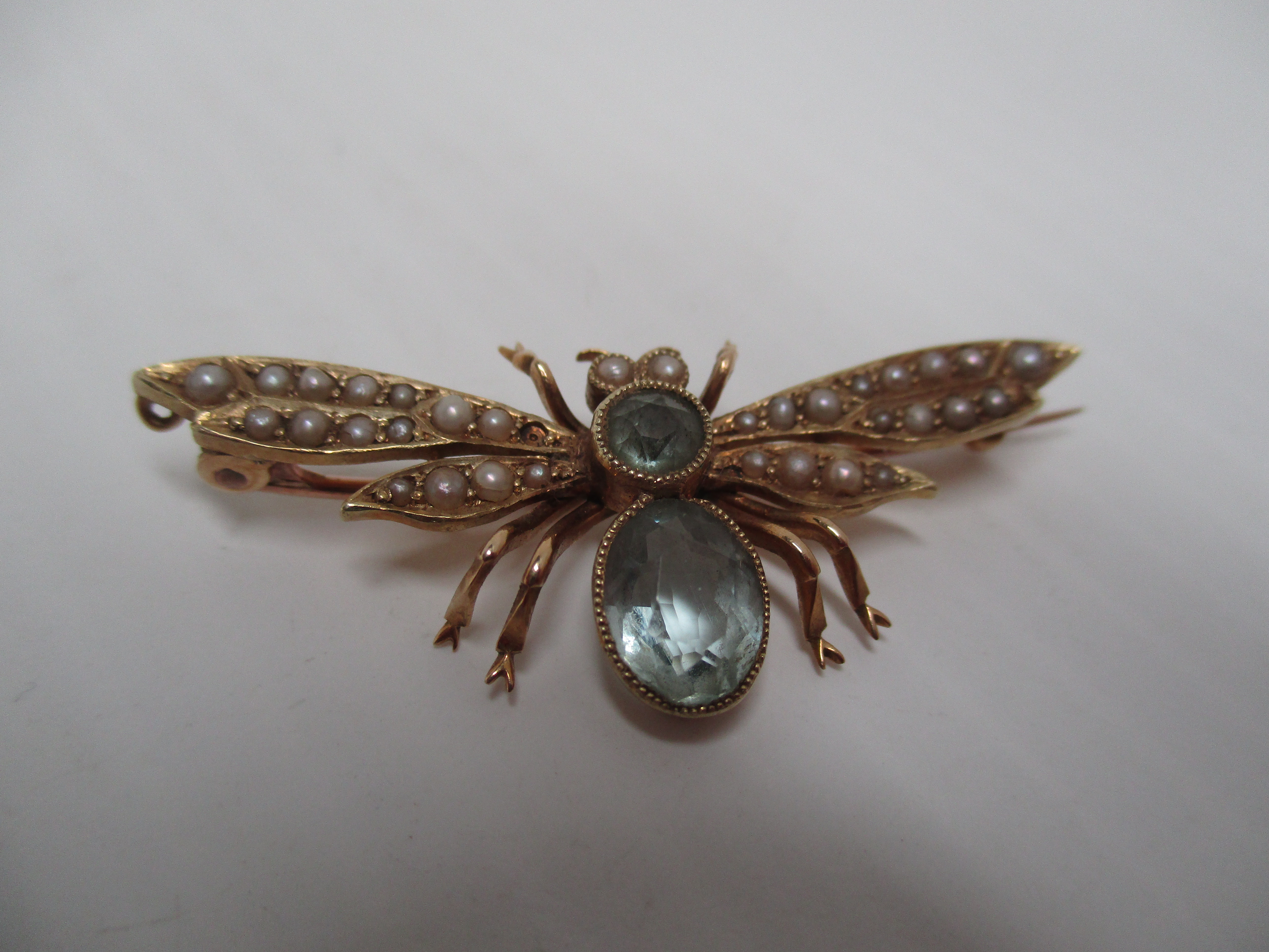 A 15ct gold insect brooch set with seed pearls and aquamarine (total wt ...