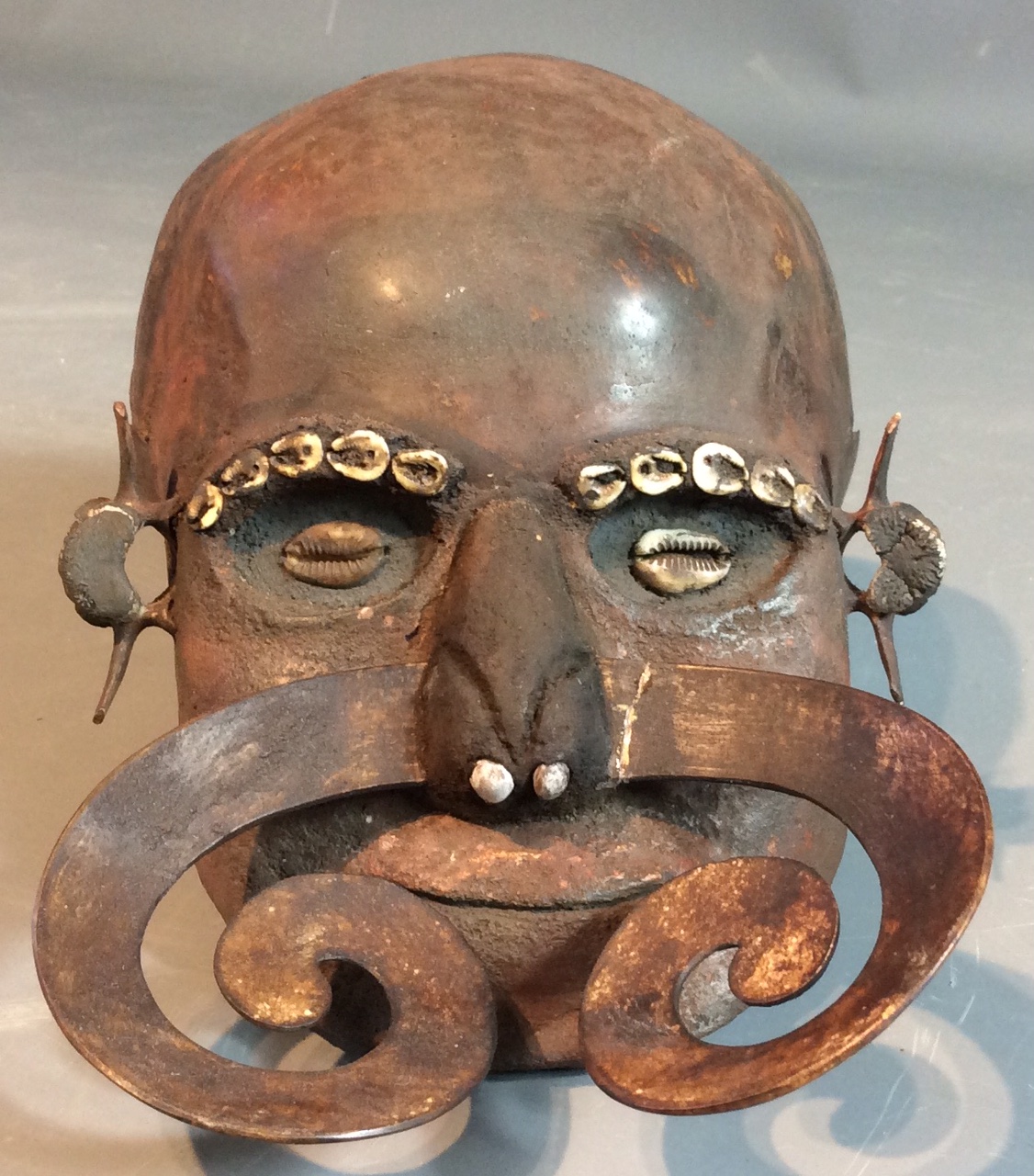A 19TH CENTURY TRIBAL HUMAN SKULL FROM PAPUA NEW GUINEA. (h 16cm x w ...