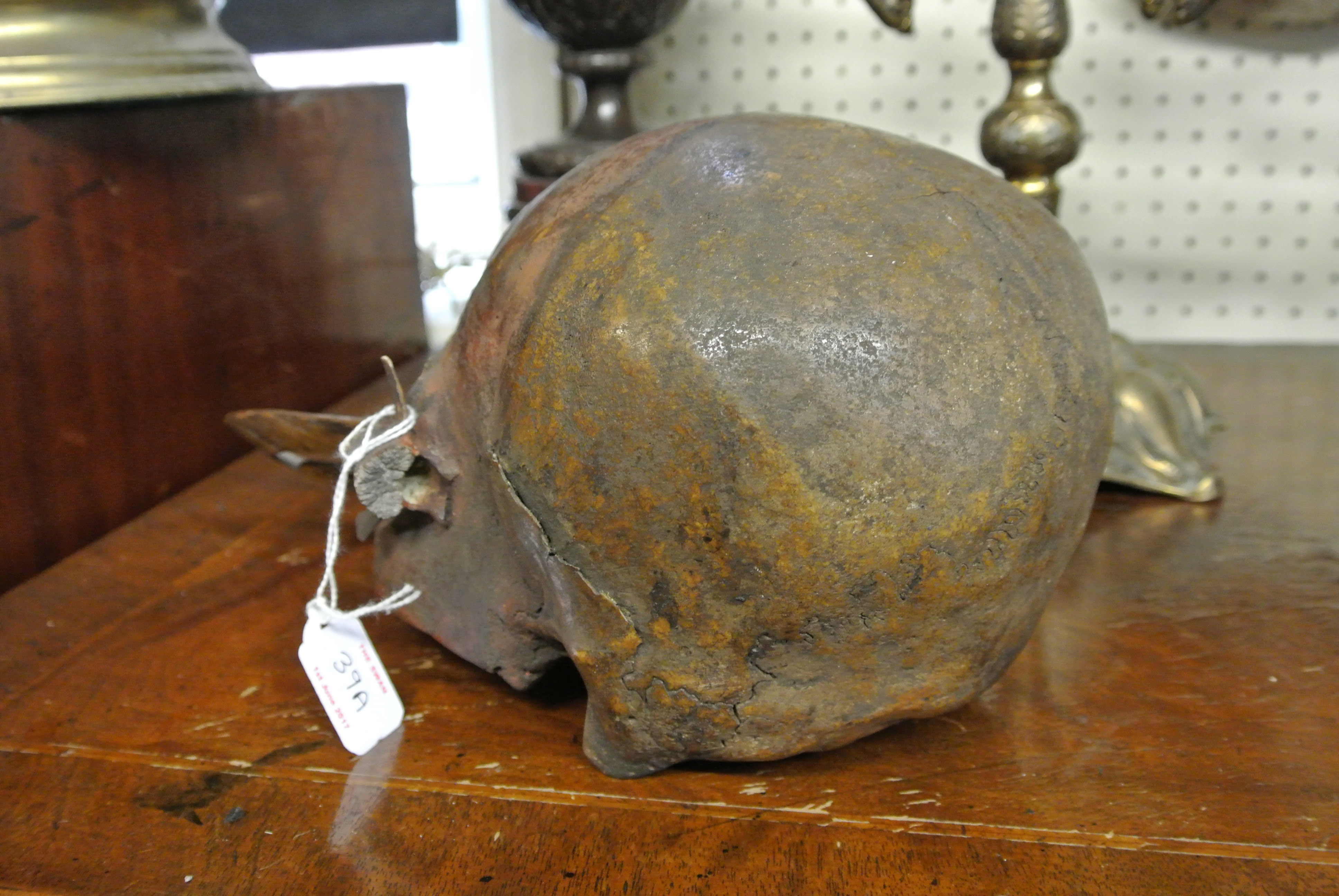 A 19TH CENTURY TRIBAL HUMAN SKULL FROM PAPUA NEW GUINEA. (h 16cm x w ...