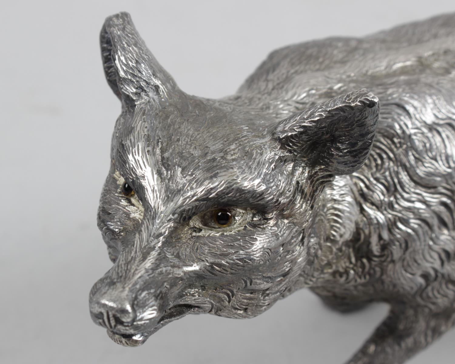 A modern silver figure of a fox, modelled in a stalking and snarling ...