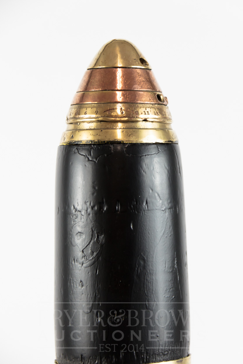 A 76mm shell case with copper and brass head, c1915