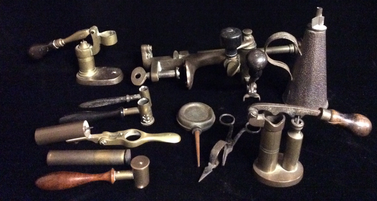 A COLLECTION OF ANTIQUE BRASS SHOTGUN Reloading tools, three hand ...