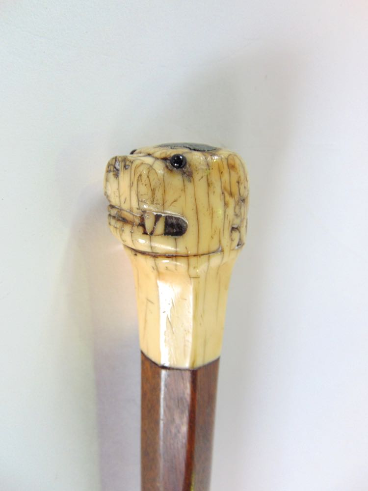 A Victorian gentleman's walking cane with lead loaded ivory knop carved ...