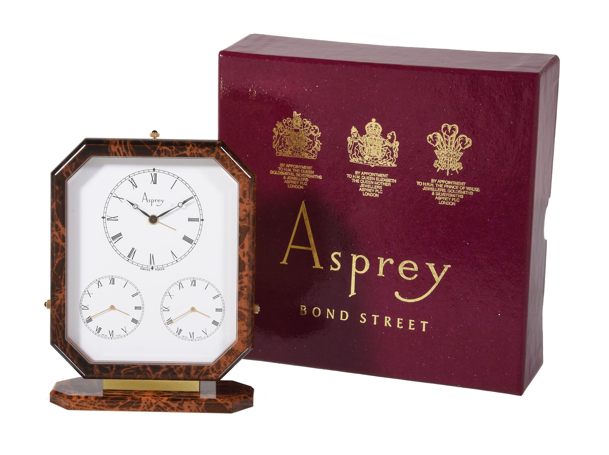 Asprey, a gilt metal and brown lacquer triple time zone alarm desk ...