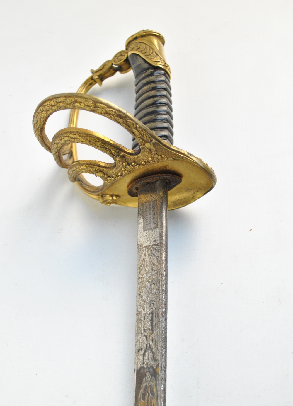 A Belgian officer's sword with pierced and gilded knuckle guard, the ...