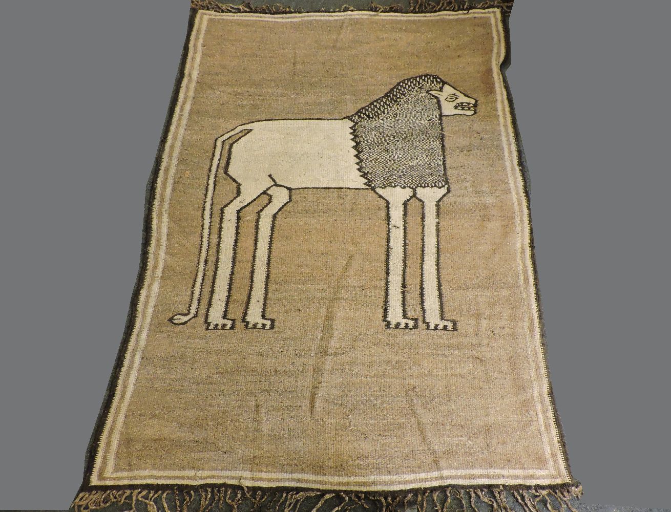 An Ethiopian camel and goat hair rug, woven with a motif of the lion of ...