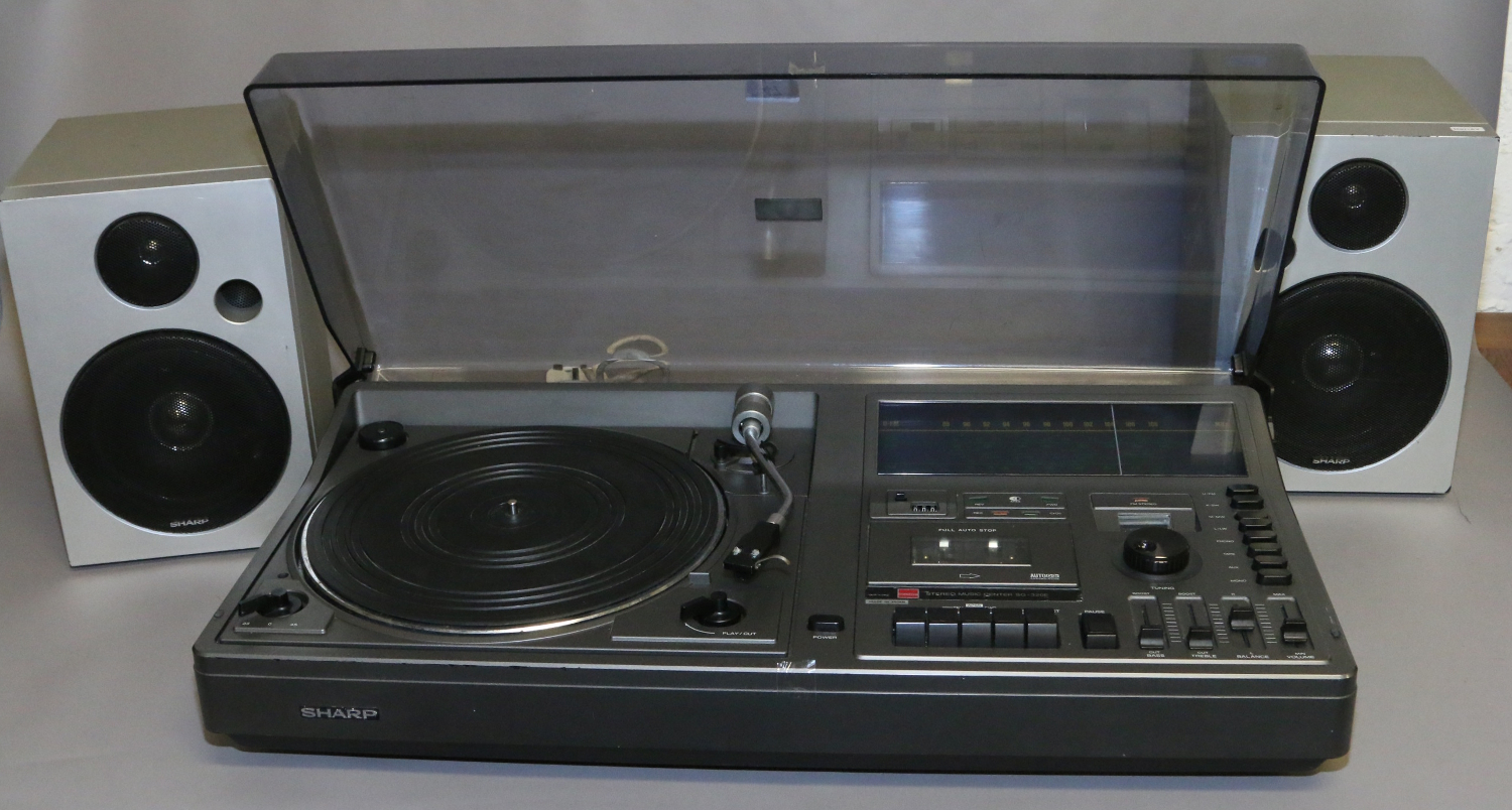 A Sharp SG-320E stereo music centre with two speakers