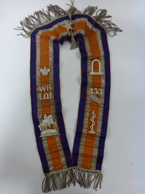Two Irish Orange Order sashes with assorted badge embellishments.