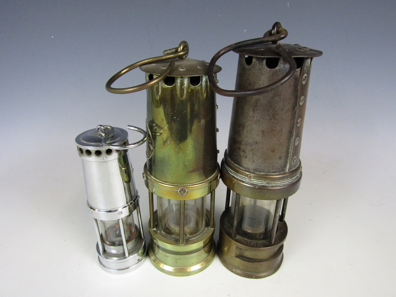 Three vintage miners' lamps