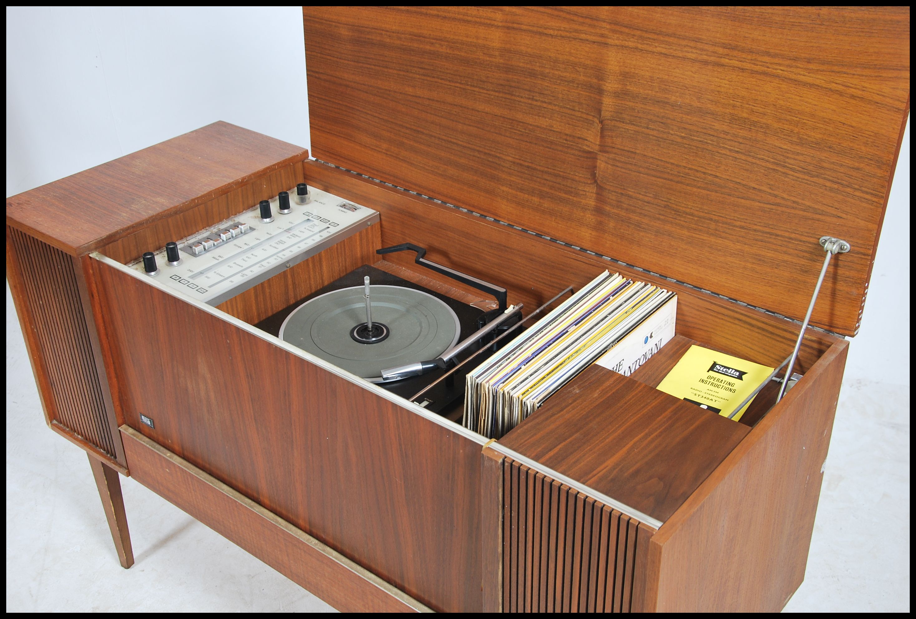 A retro 1970's teak wood cabinet radiogram by Stella, with a lift up ...