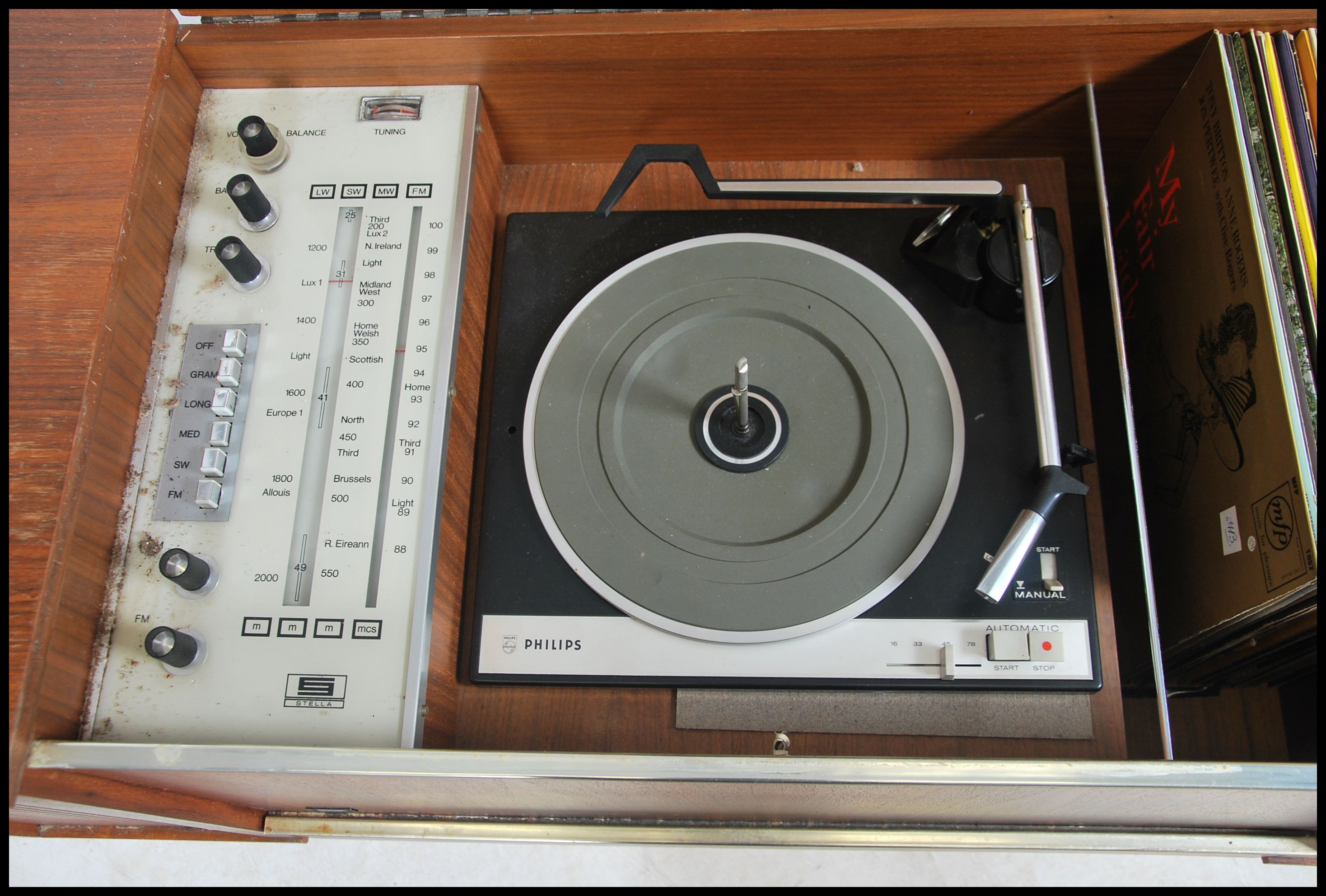 A retro 1970's teak wood cabinet radiogram by Stella, with a lift up ...