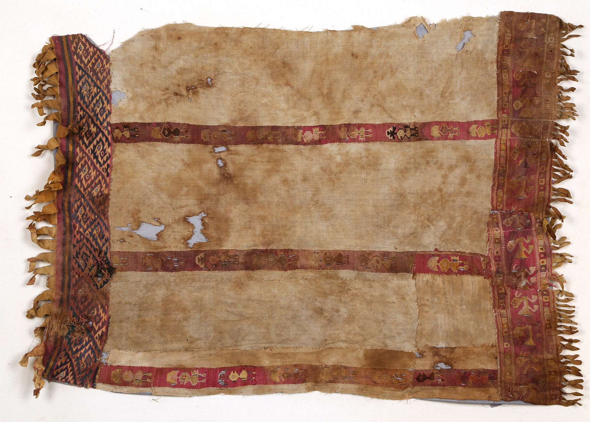 TWO MOCHE TEXTILE FRAGMENTS, PERU Including a tunic fragment, composed ...