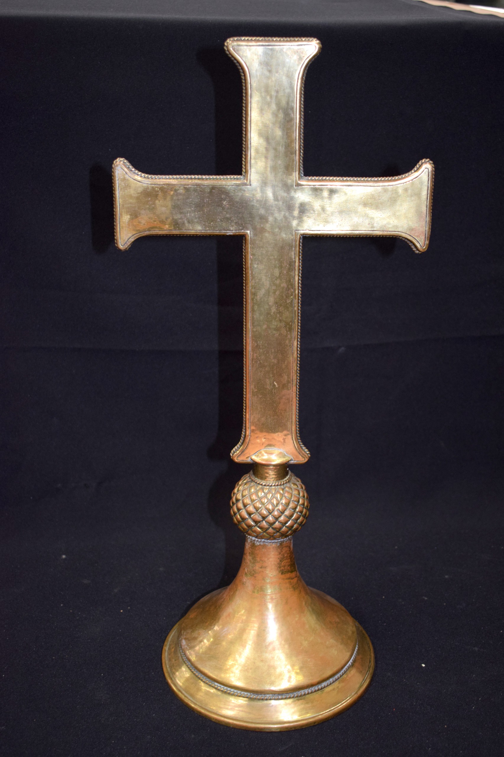 A LARGE BRASS RELIGIOUS CROSS, on flared pedestal base. 52 cm high.