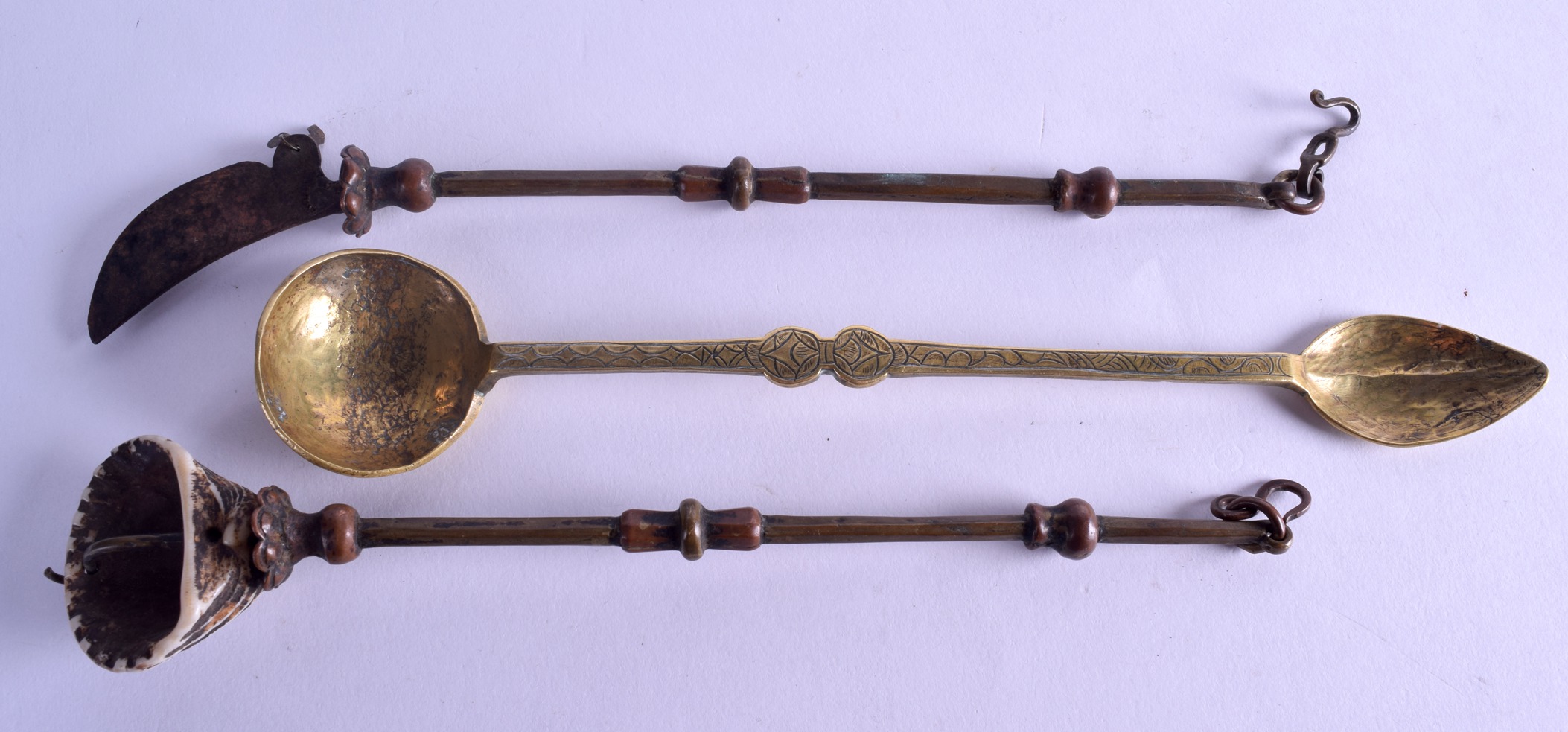 AN EARLY ISLAMIC DOUBLE ENDED BRASS SPOON together with a horn handle ...