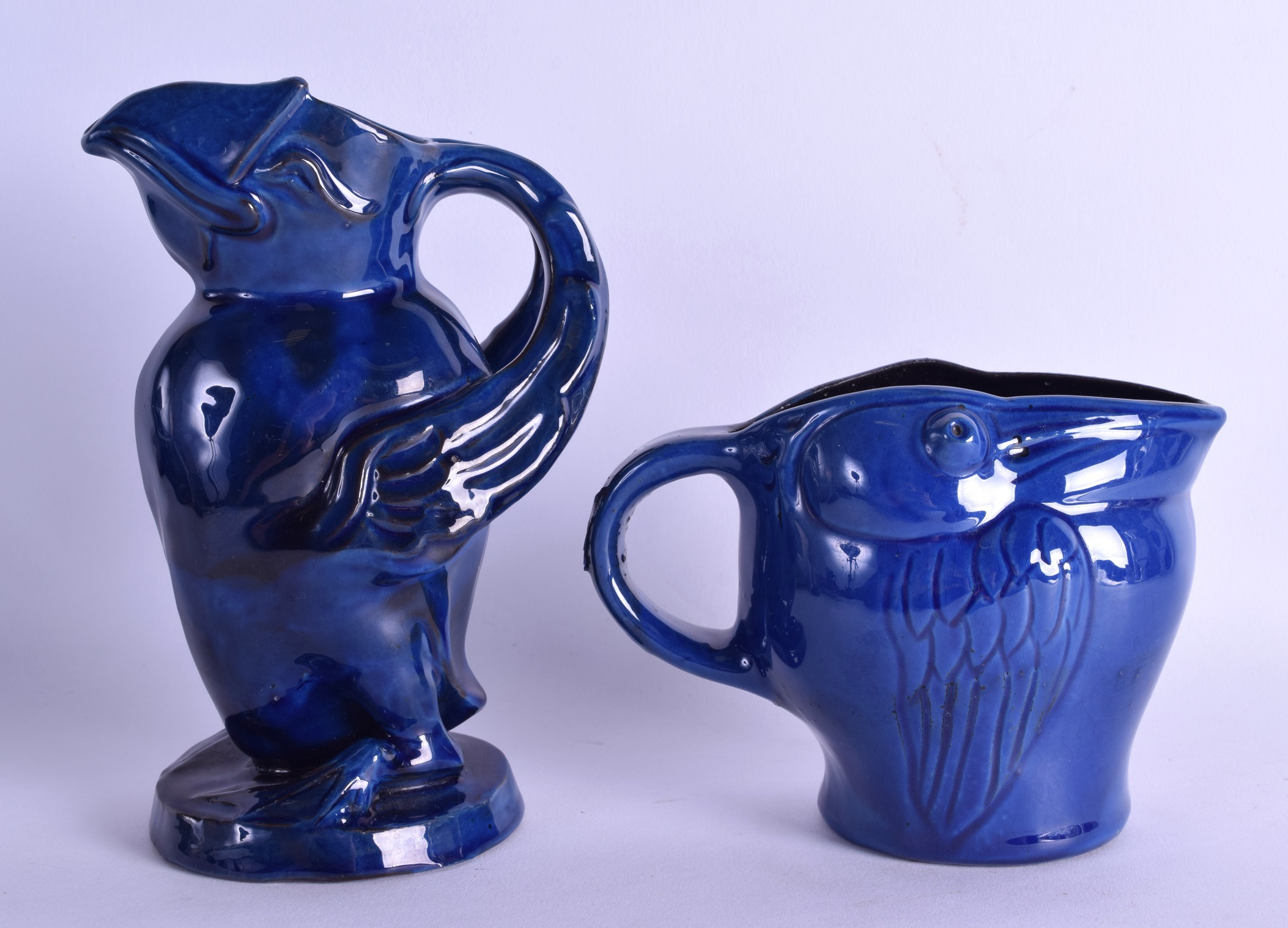 A C H BRANNAM POTTERY BIRD JUG together with a smaller bird jug. 16 cm ...