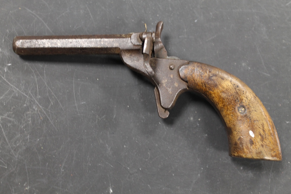 AN ANTIQUE SINGLE SHOT PISTOL WITH WOODEN HANDLEBuyer Please Note: This ...