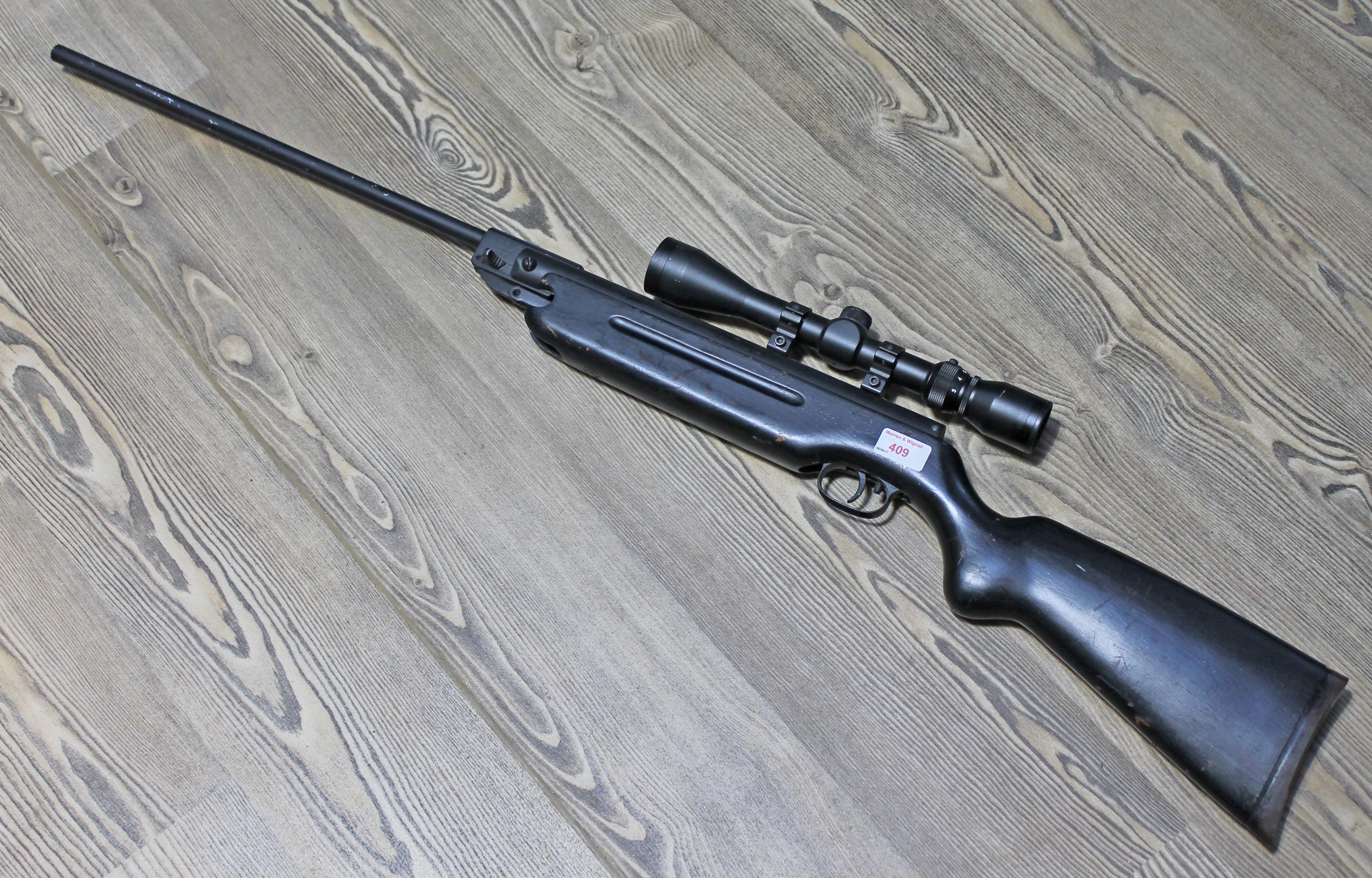 A Weihrauch HW80 air rifle with scope, length 115cm.