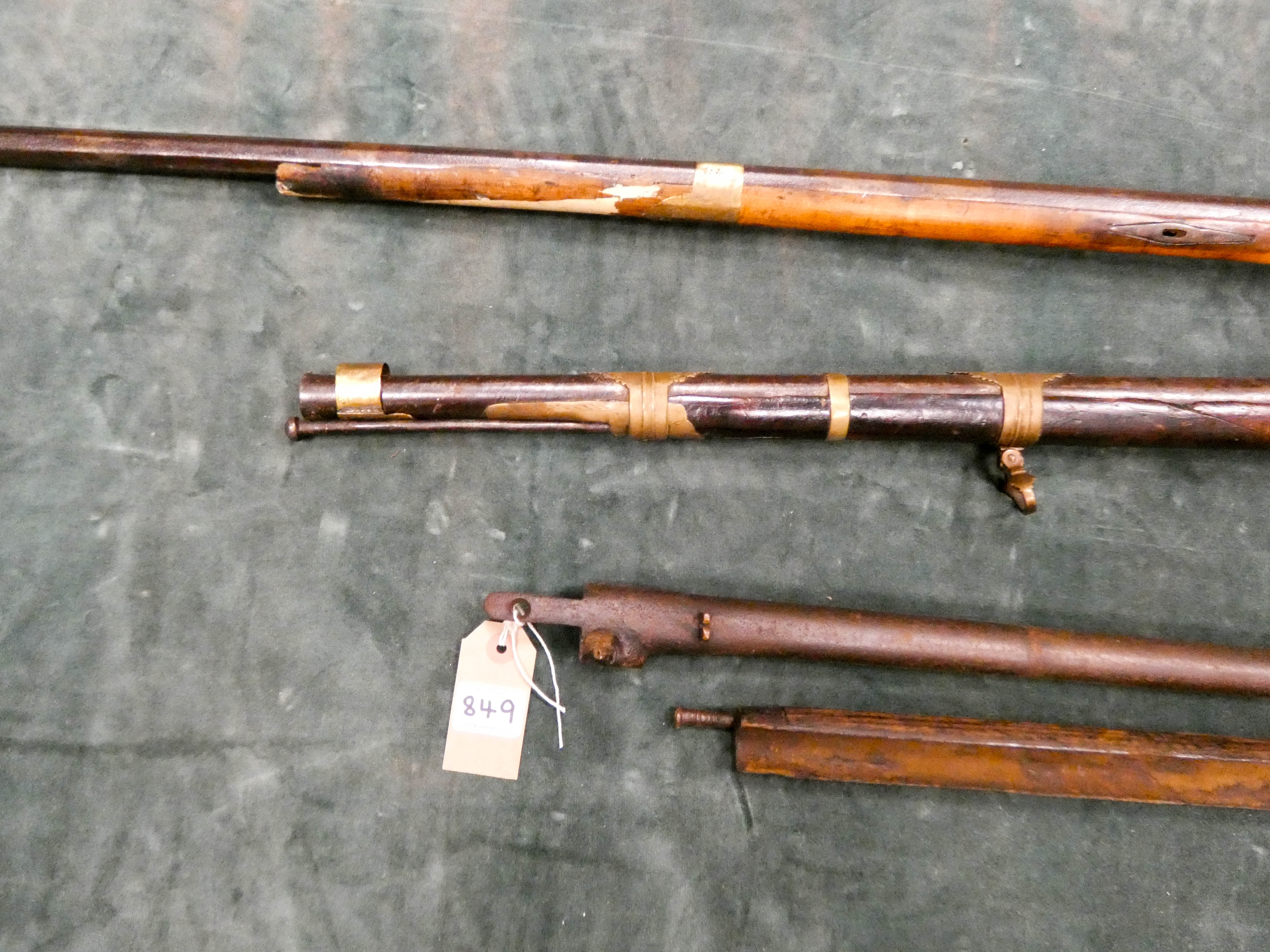 Two old Indian guns, the first a flint lock with octagonal barrel, the ...